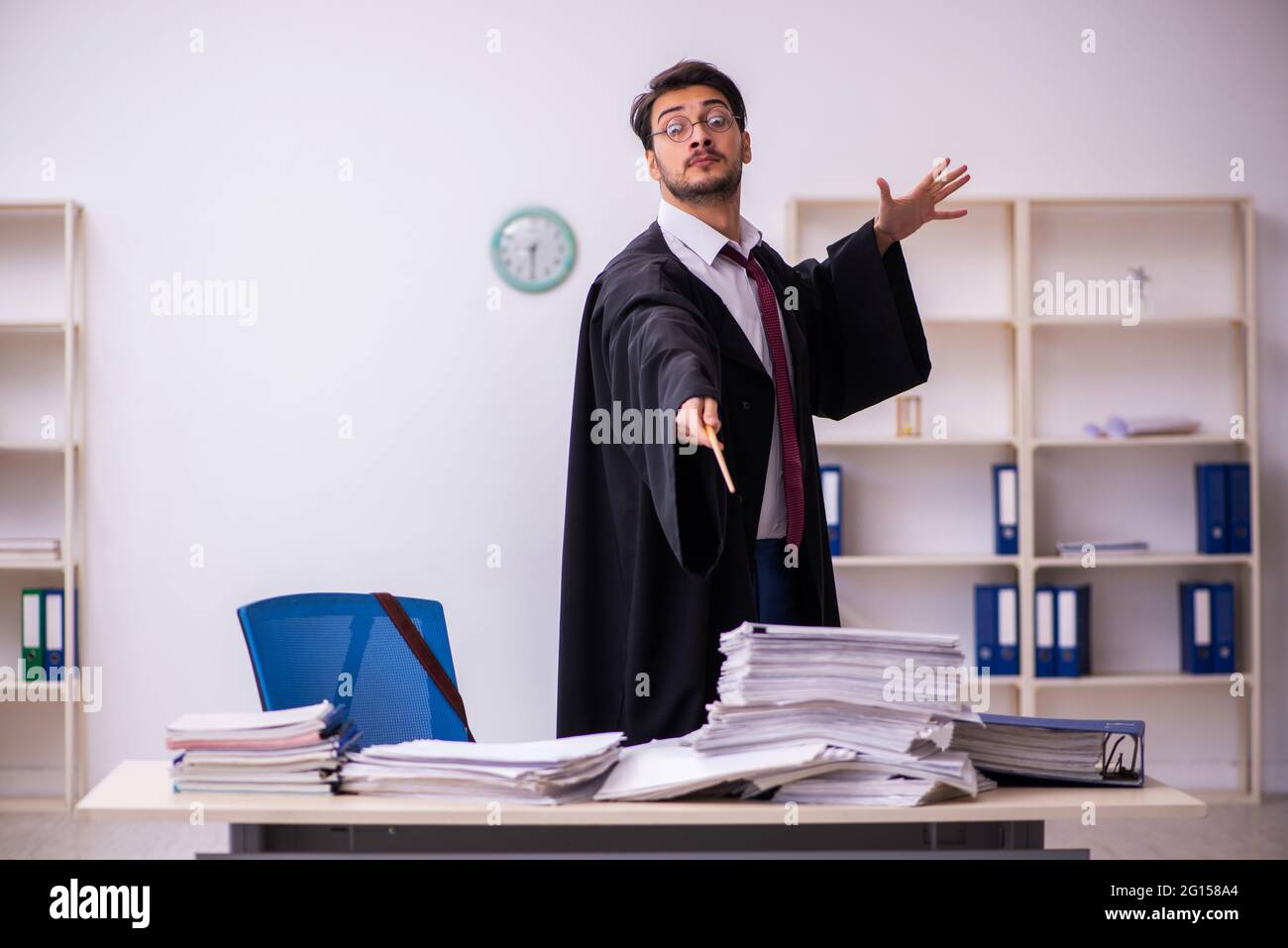 Funny young employee magician and too much work in the office Stock ...