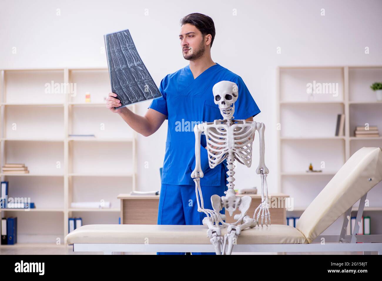 Young doctor radiologist examining skeleton patient Stock Photo - Alamy