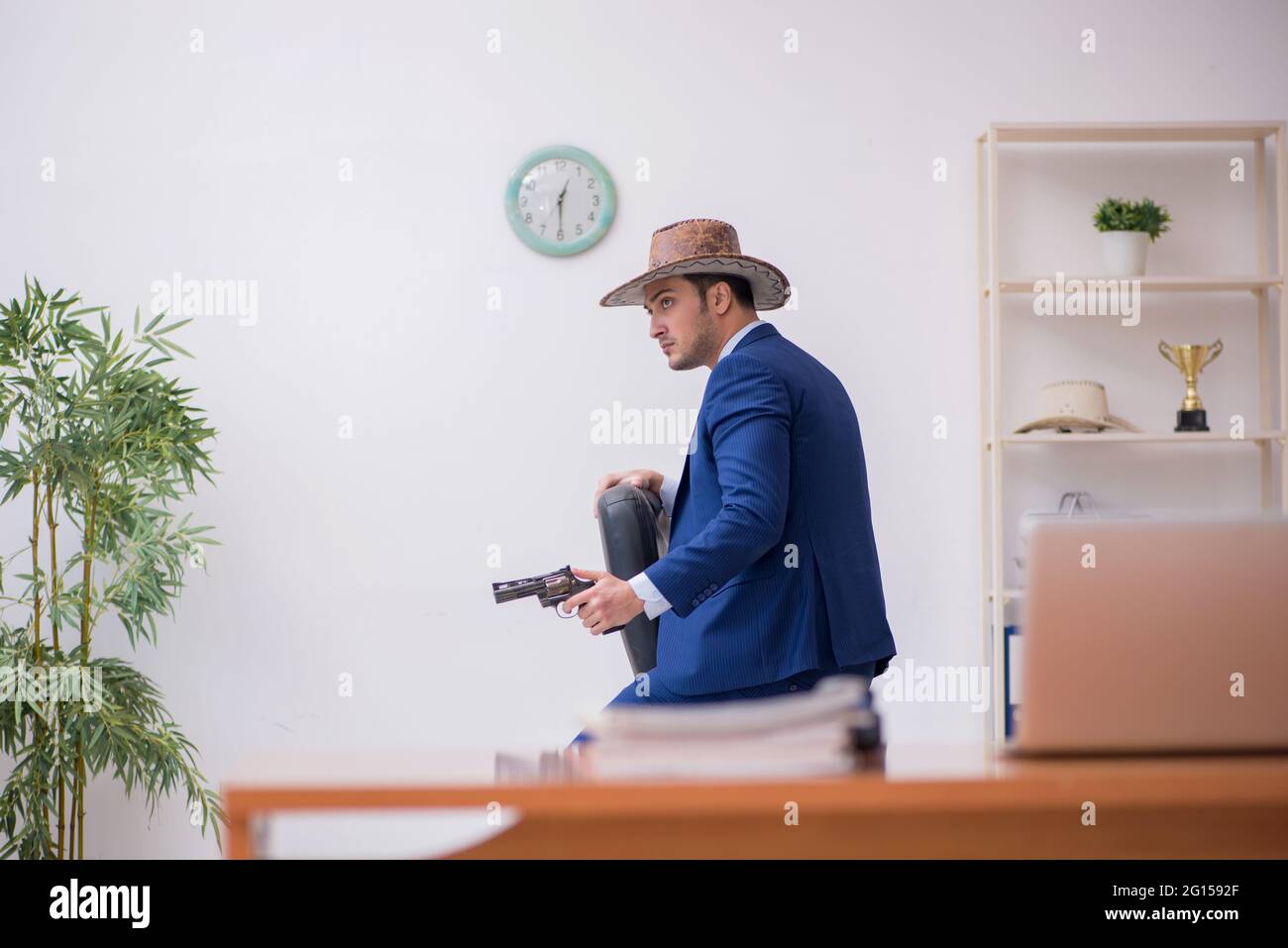 Young cowboy employee working at workplace Stock Photo - Alamy