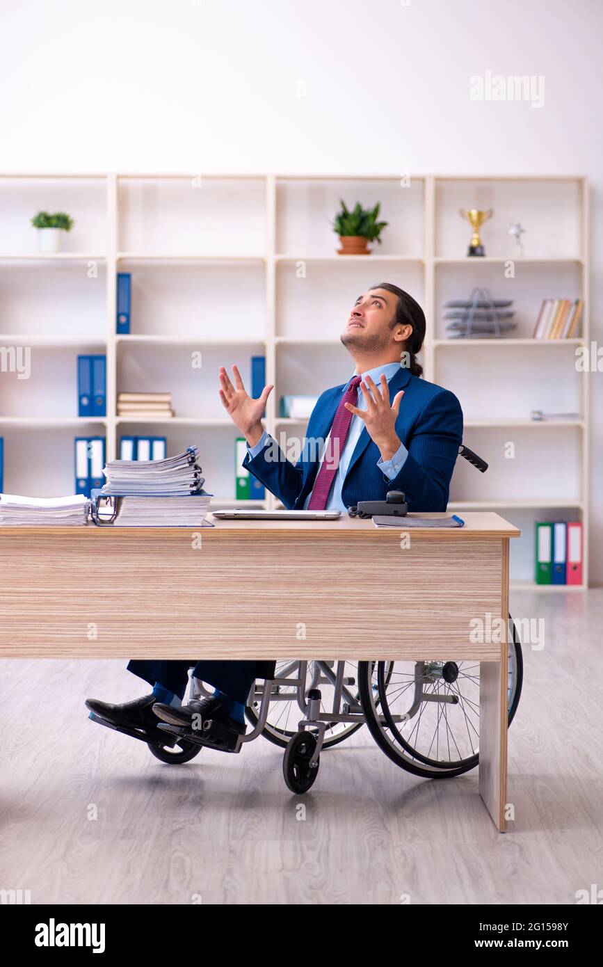 Young male disabled employee working in the office Stock Photo - Alamy