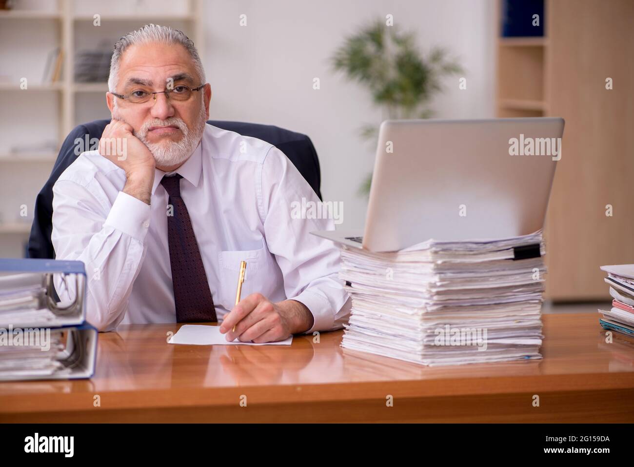 Old male employer and too much work at workplace Stock Photo - Alamy