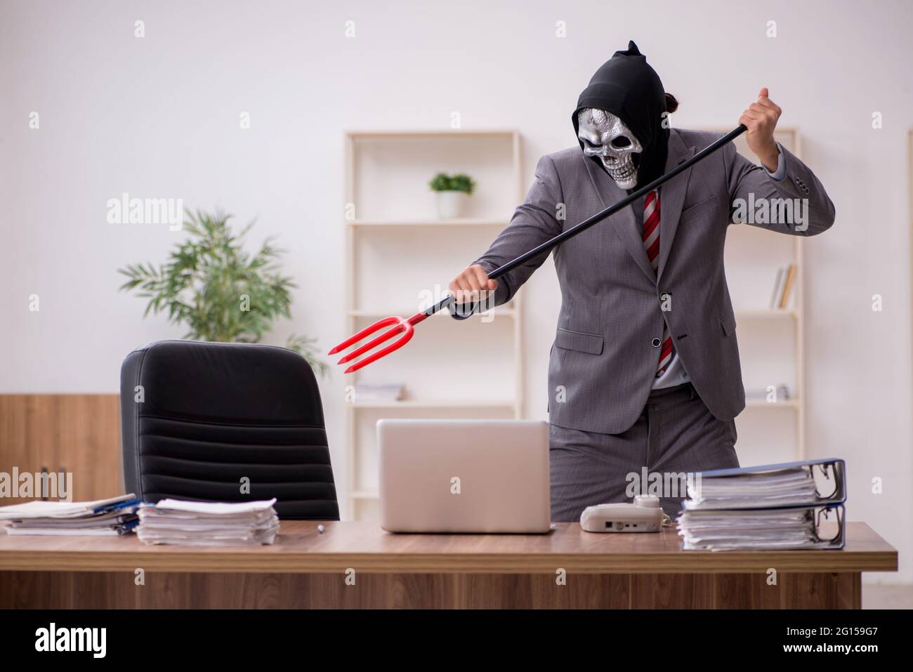 Devil businessman employee working in the office Stock Photo - Alamy