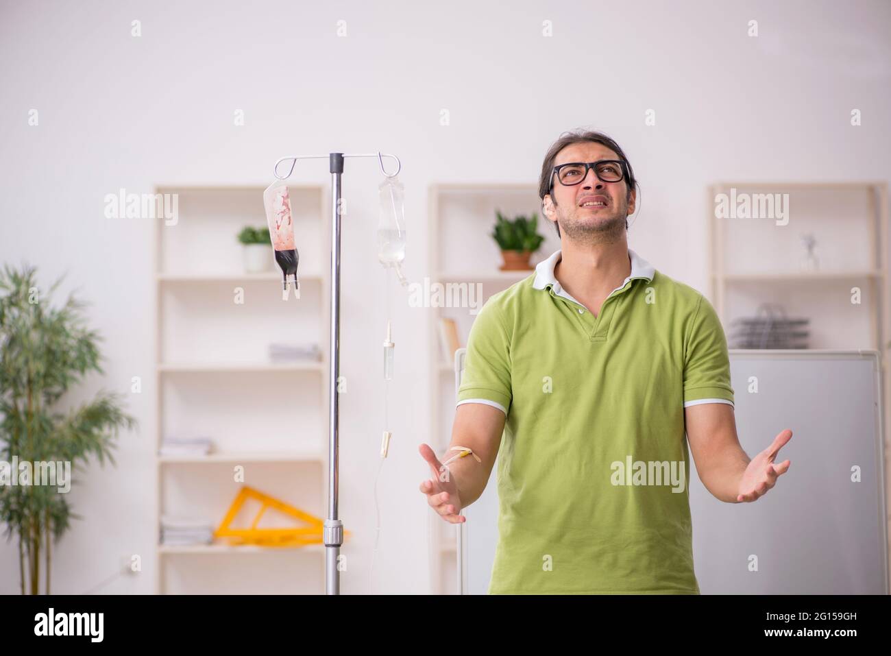 Young sick teacher student in blood transfusion concept Stock Photo - Alamy
