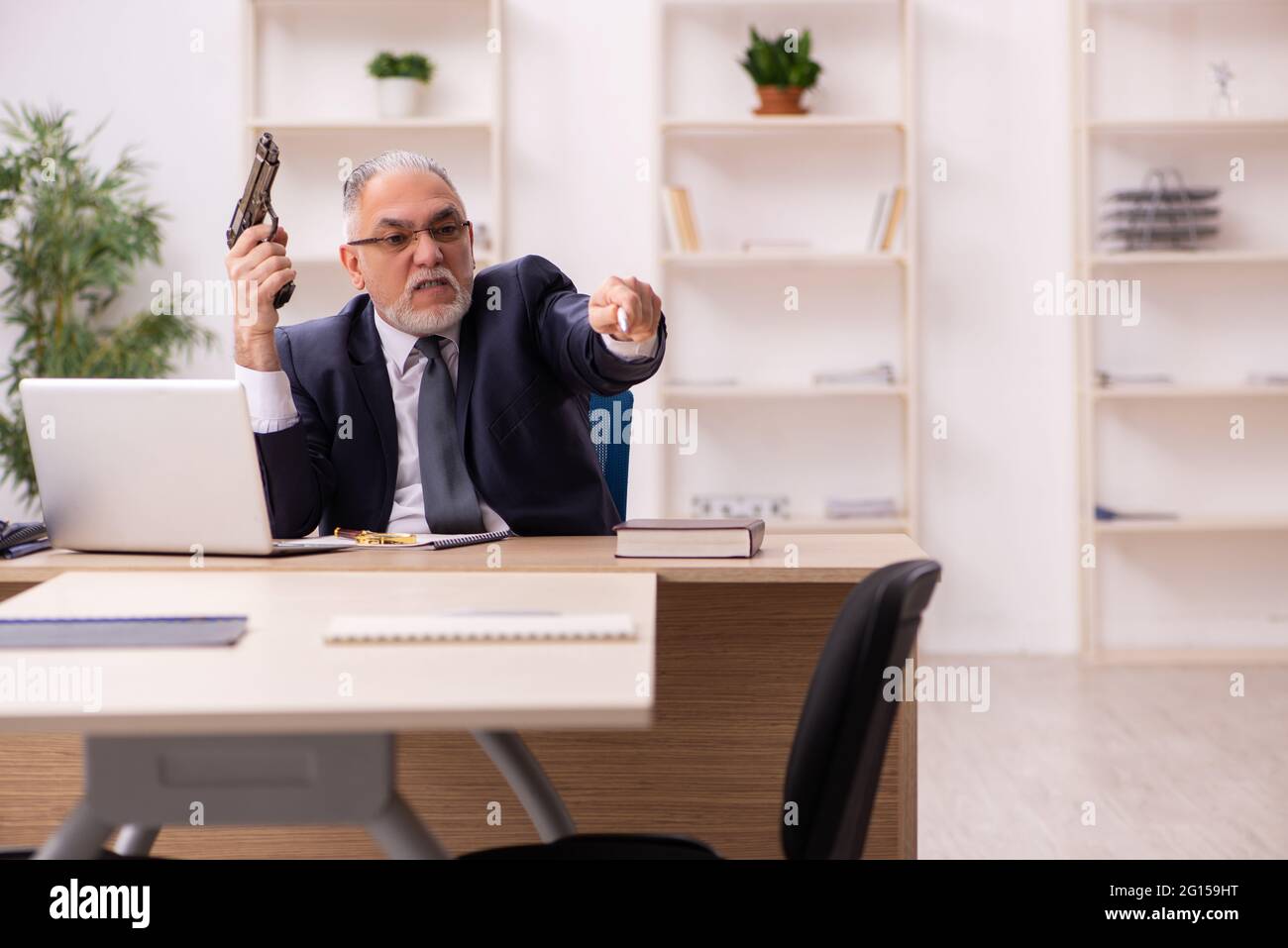 Angry businessman aiming gun hi-res stock photography and images - Alamy