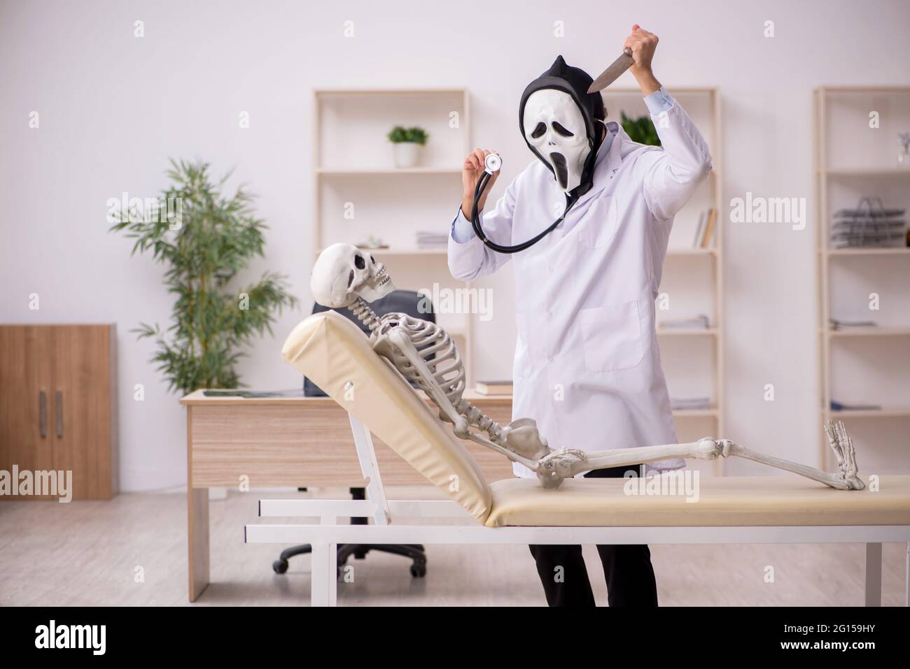 Devil doctor examining skeleton patient in the clinic Stock Photo - Alamy