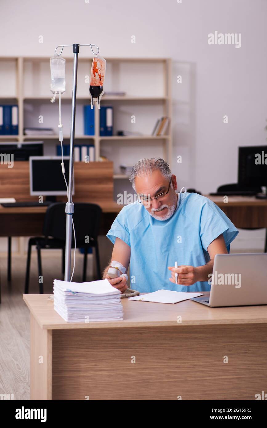 Old businessman employee in blood transfusion concept Stock Photo - Alamy