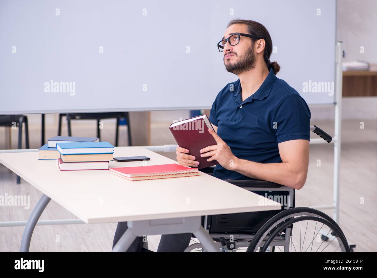 Young handicapped student in the classroom Stock Photo - Alamy