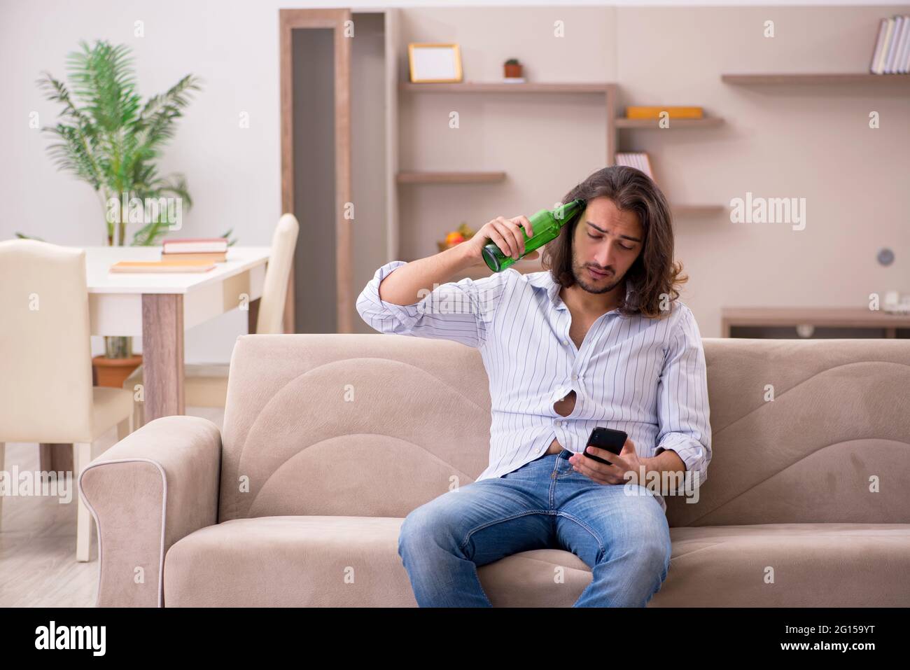 Man drinking alcohol at home Stock Photo - Alamy