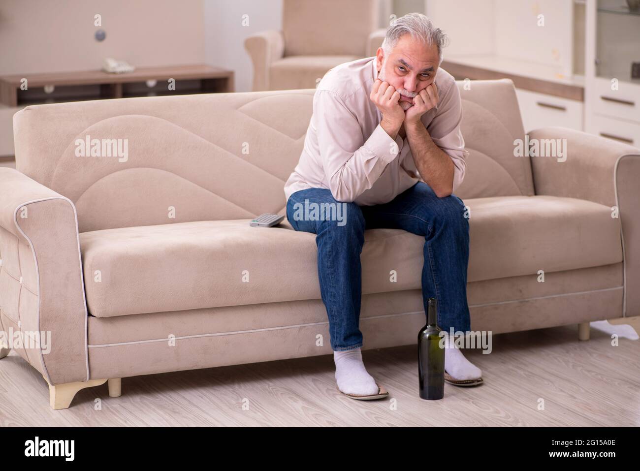 Aged man drinking alcohol at home Stock Photo - Alamy