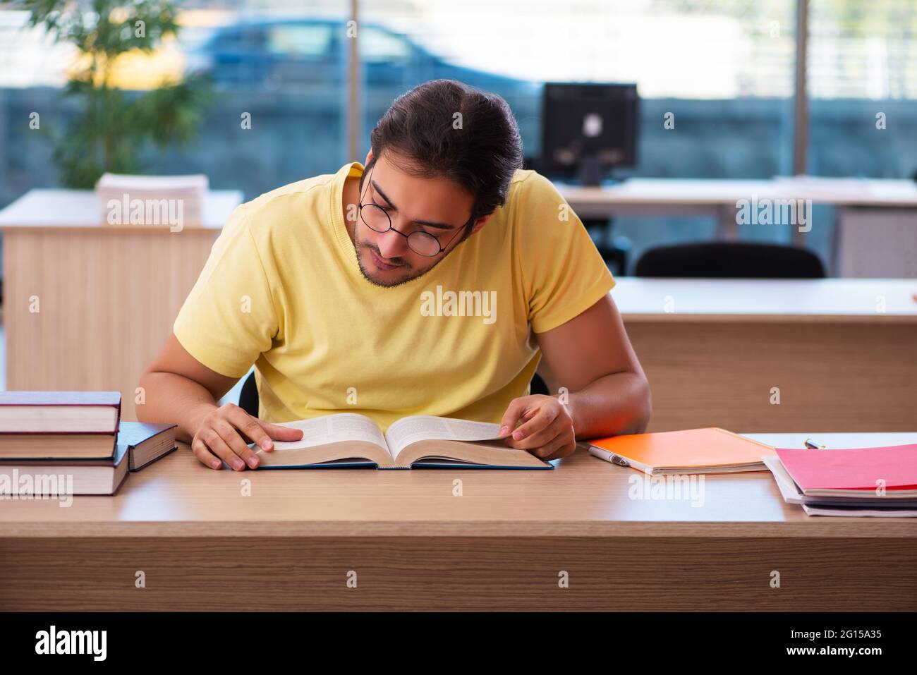 Young student preparing for exams in the classroom Stock Photo - Alamy