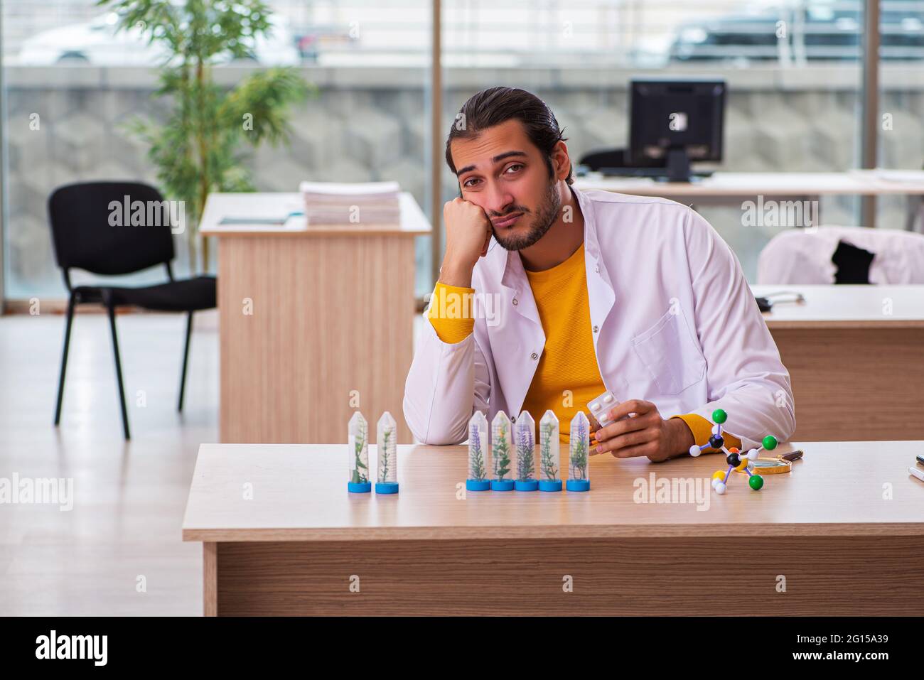 Young chemist in drug synthesis concept Stock Photo - Alamy
