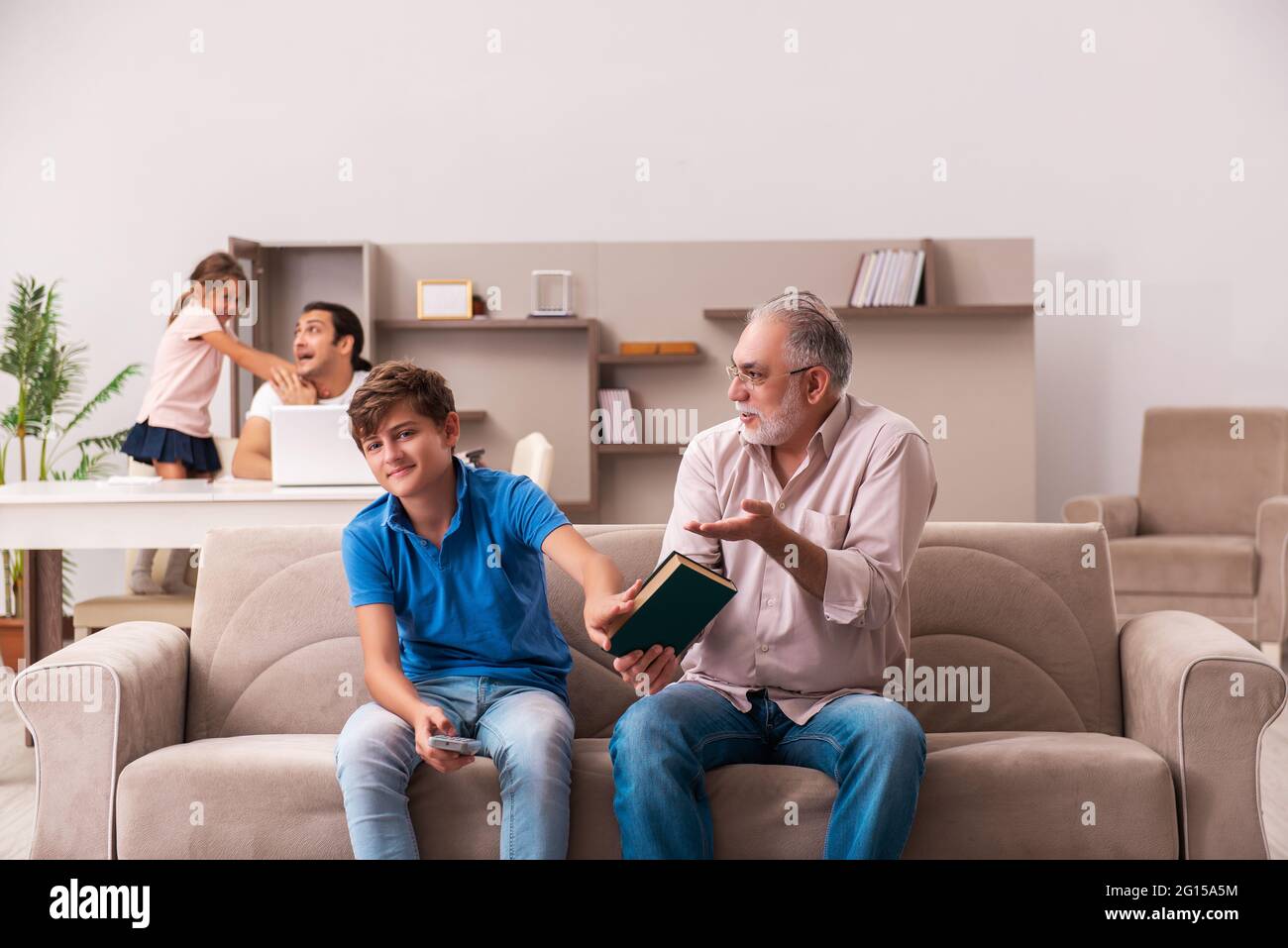 Three generations family watching tv hi-res stock photography and ...