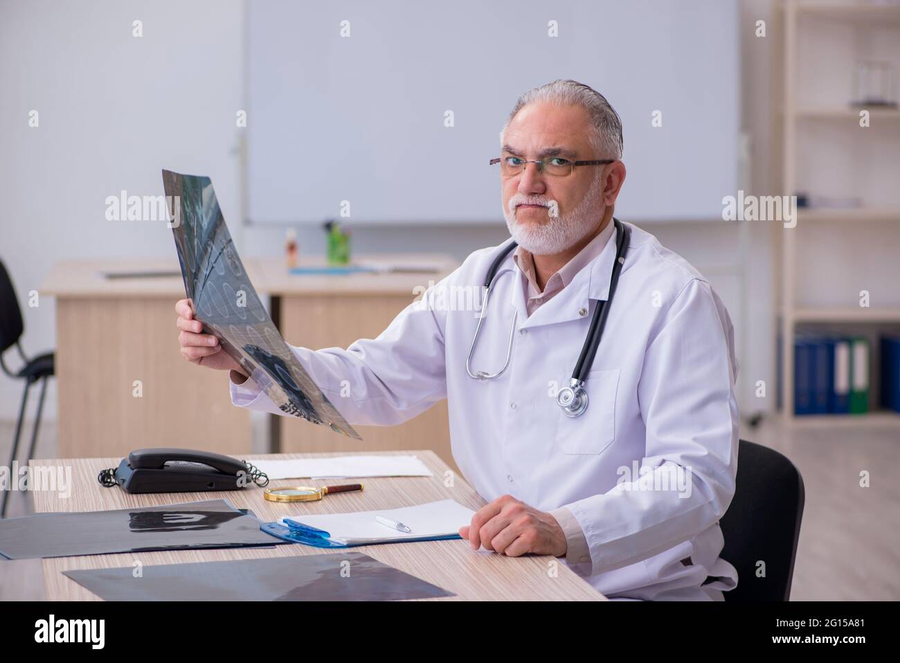 Old doctor radiologist working in the clinic Stock Photo - Alamy