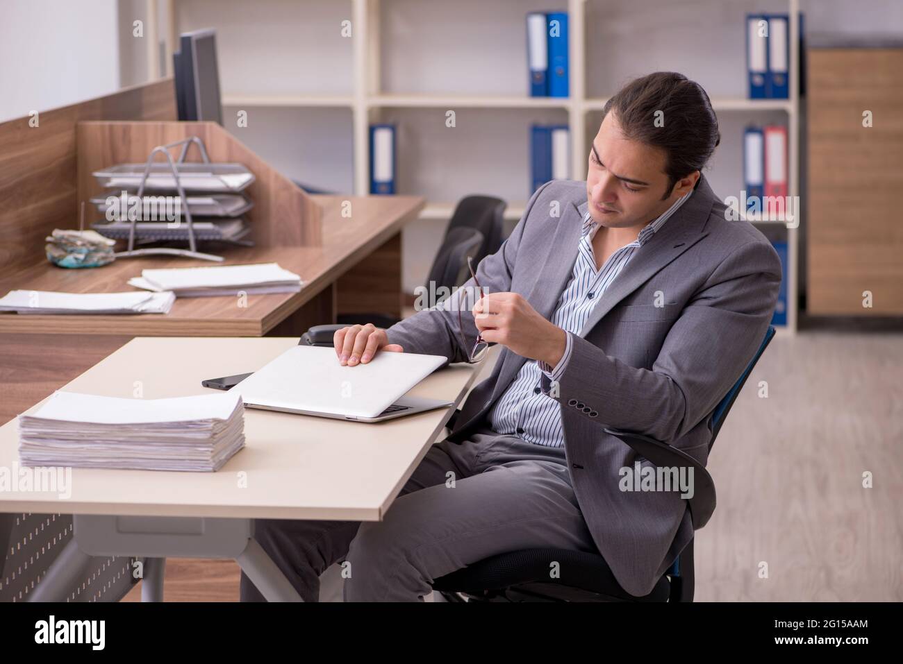 Young employee working in the office Stock Photo - Alamy
