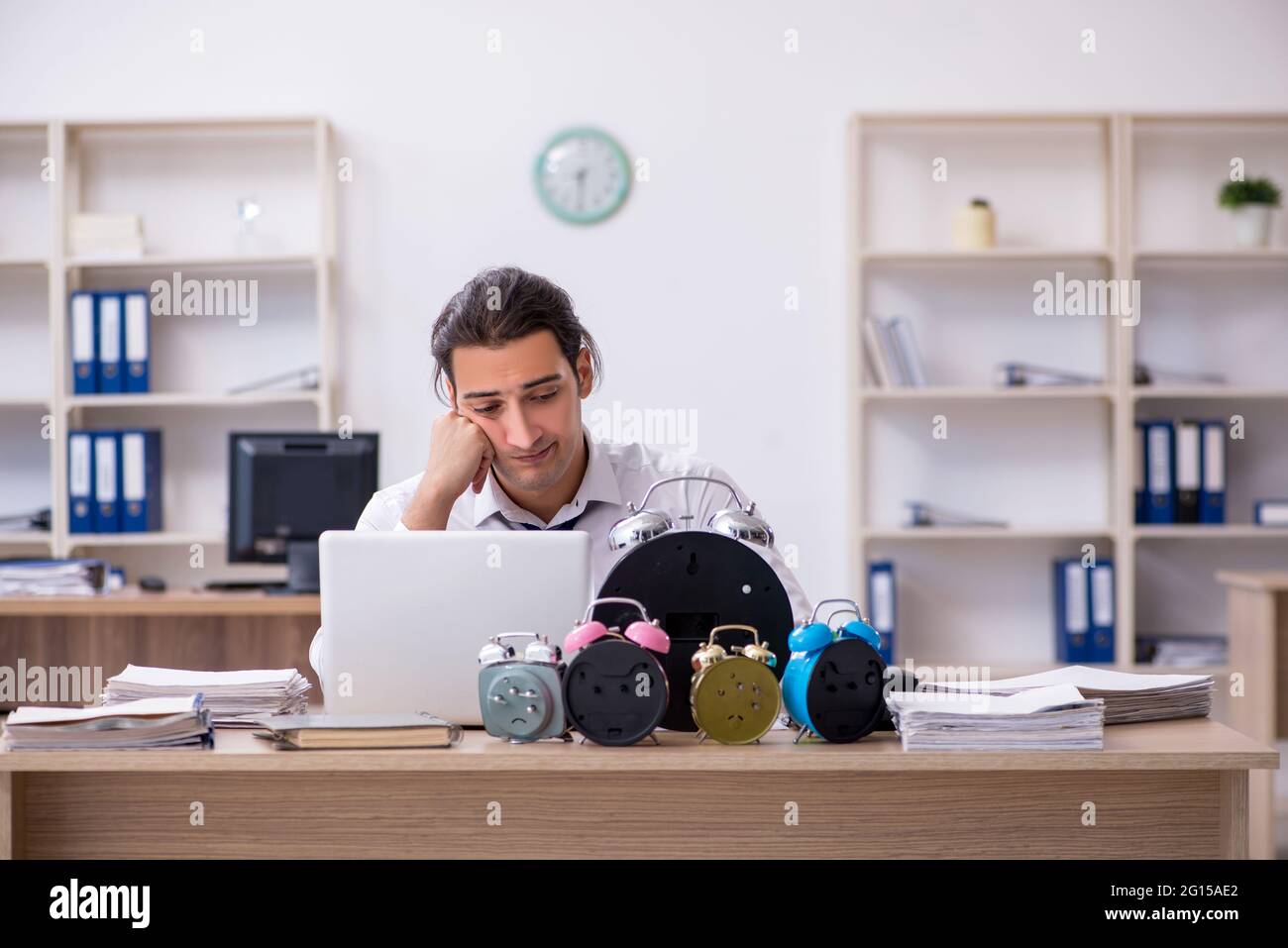 Young employee afraid of missing deadline at workplace Stock Photo - Alamy