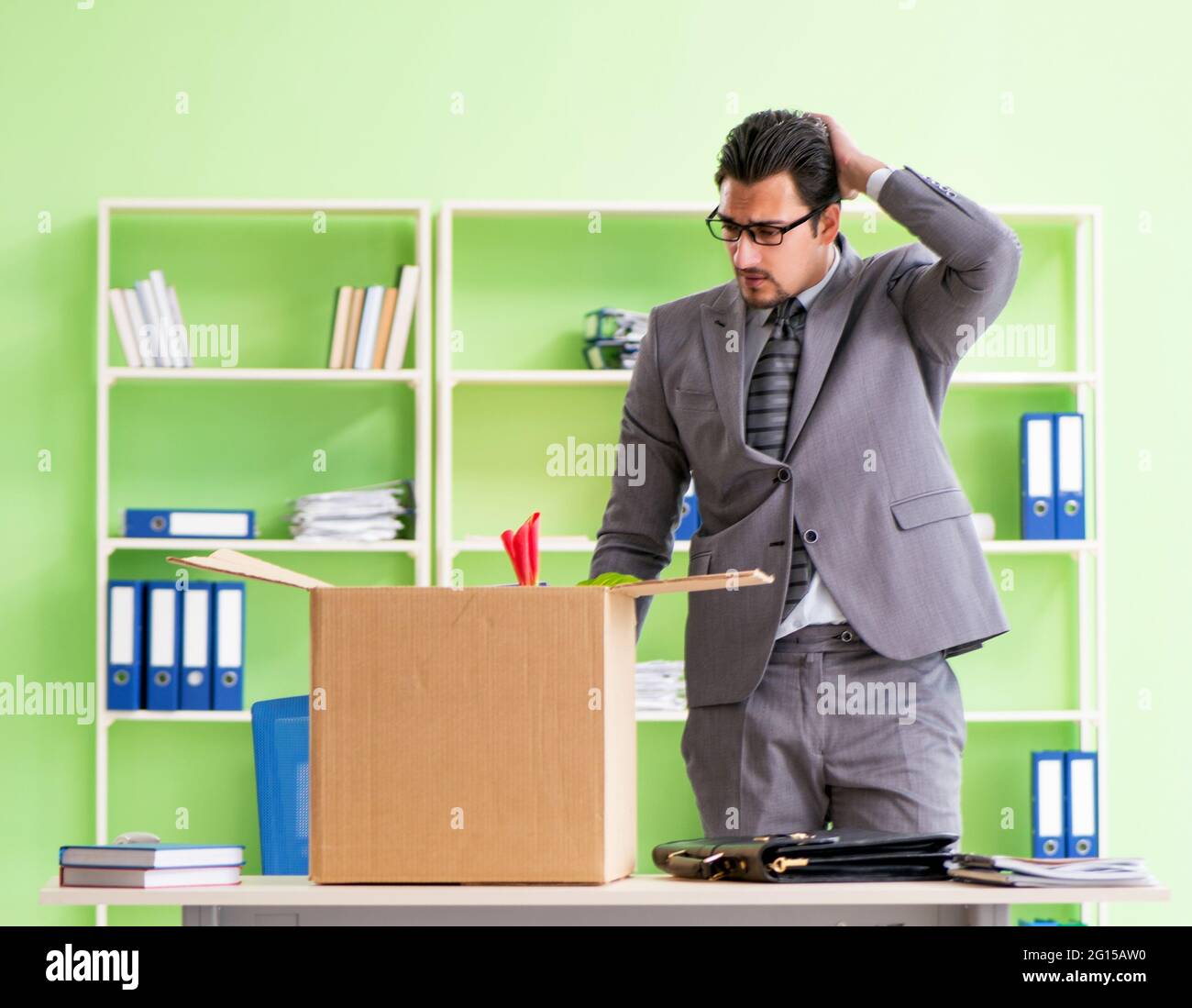 The male employee collecting his stuff after redundancy Stock Photo - Alamy