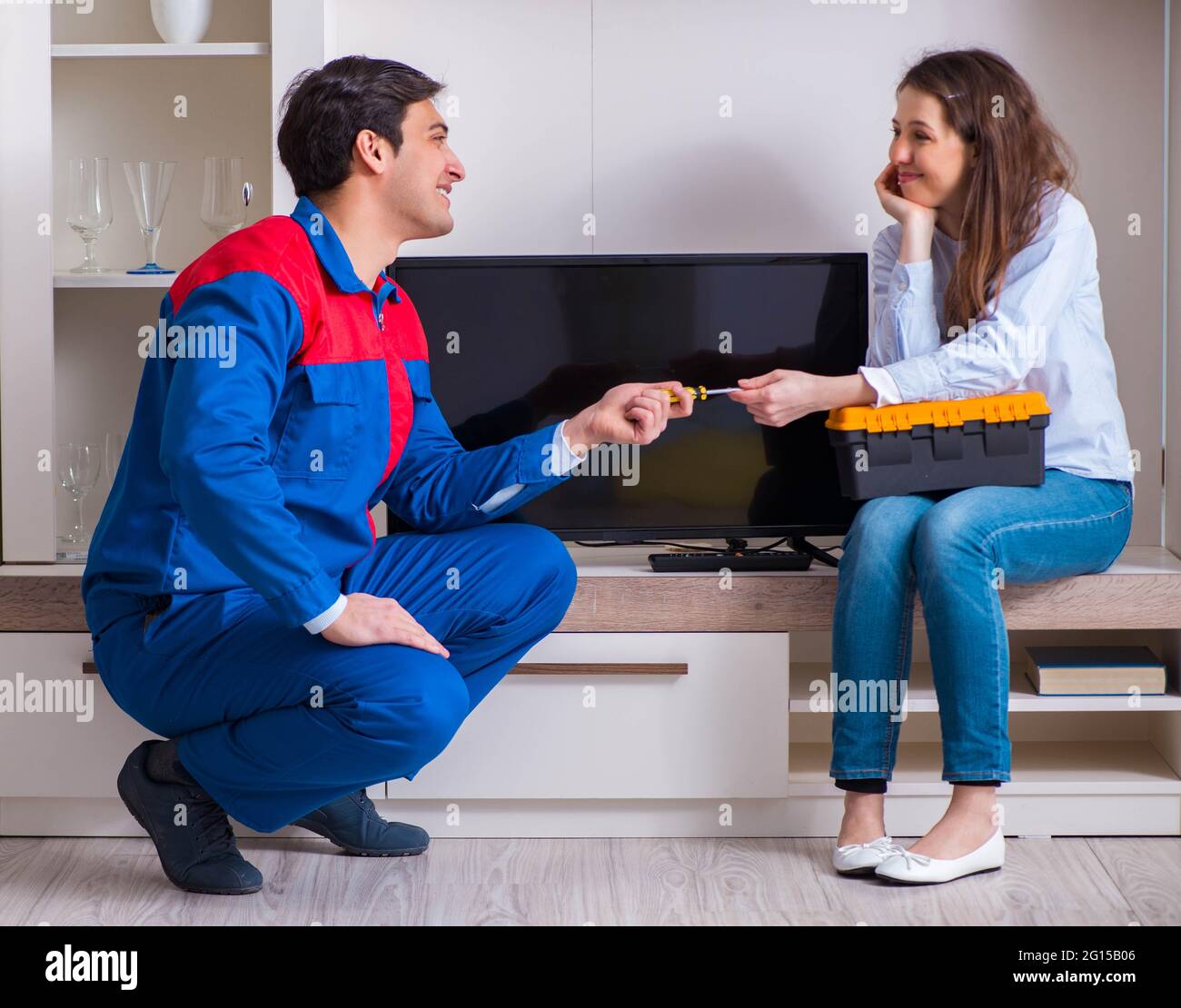 The repairman repairing tv at home Stock Photo - Alamy