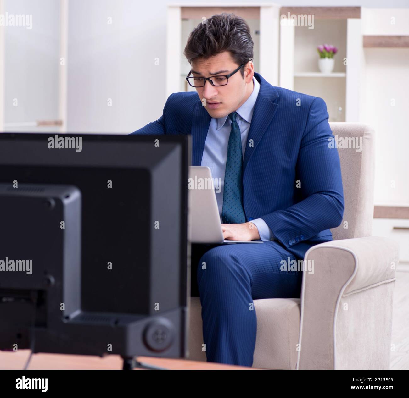 The businessman watching tv in the office Stock Photo - Alamy