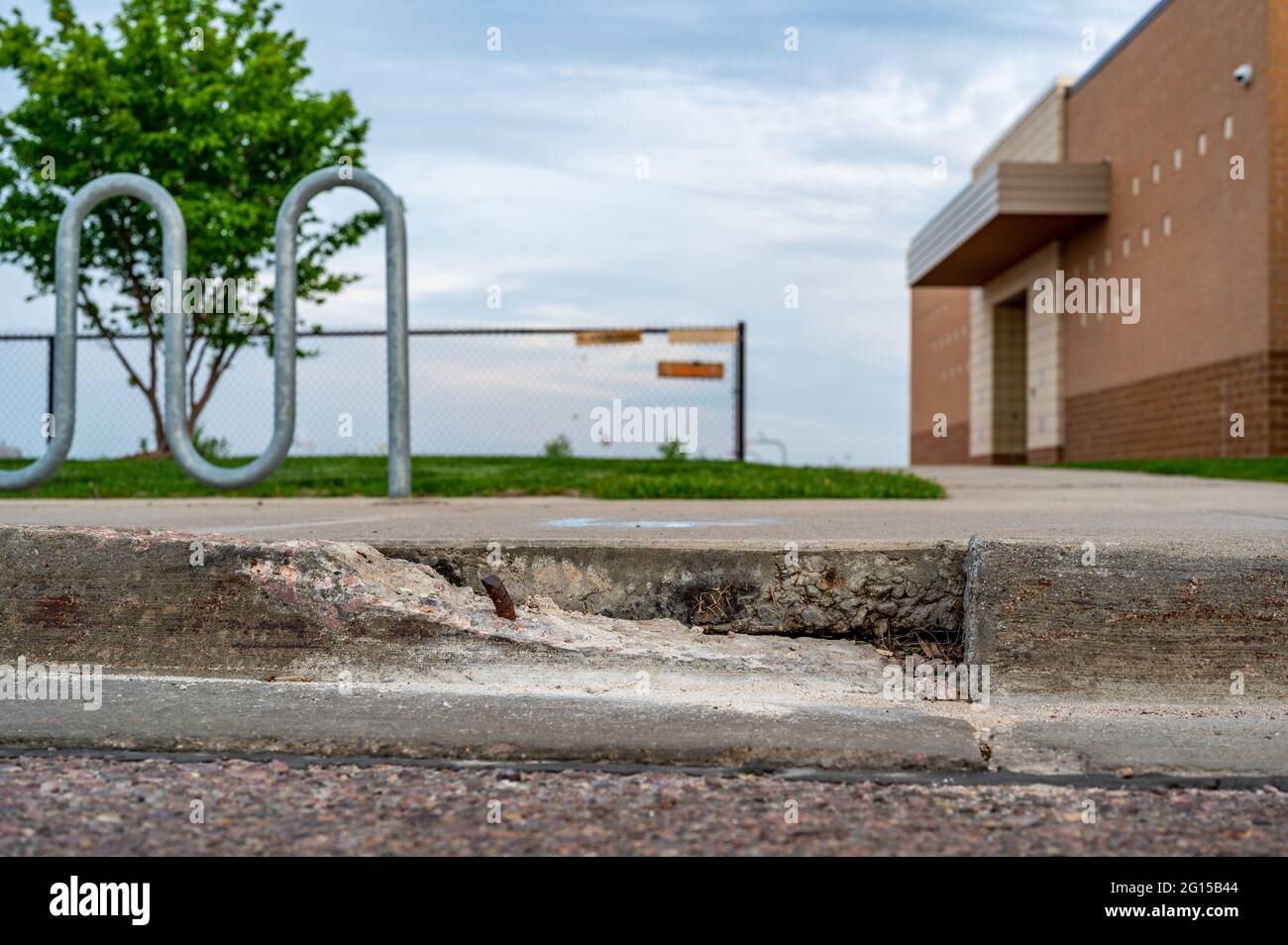 Broken sidewalk curb with exposed rebar and jagged edges that could ...