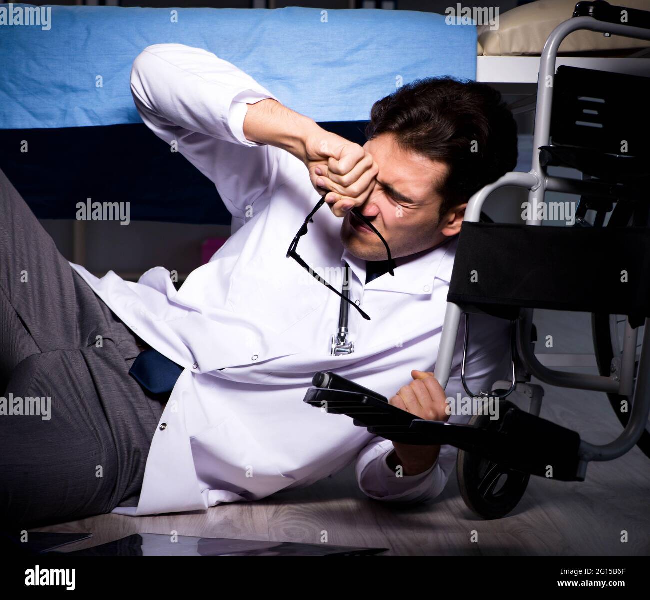 The doctor working night shift in hospital after long hours Stock Photo ...
