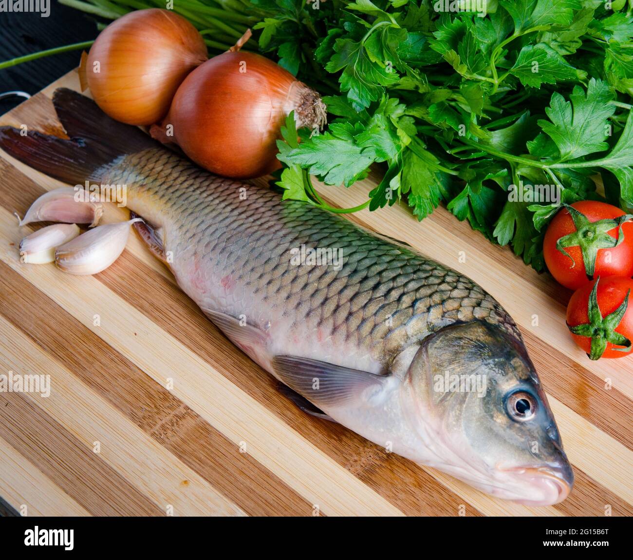The uncooked fish on cutting board in meal preparation concept Stock ...