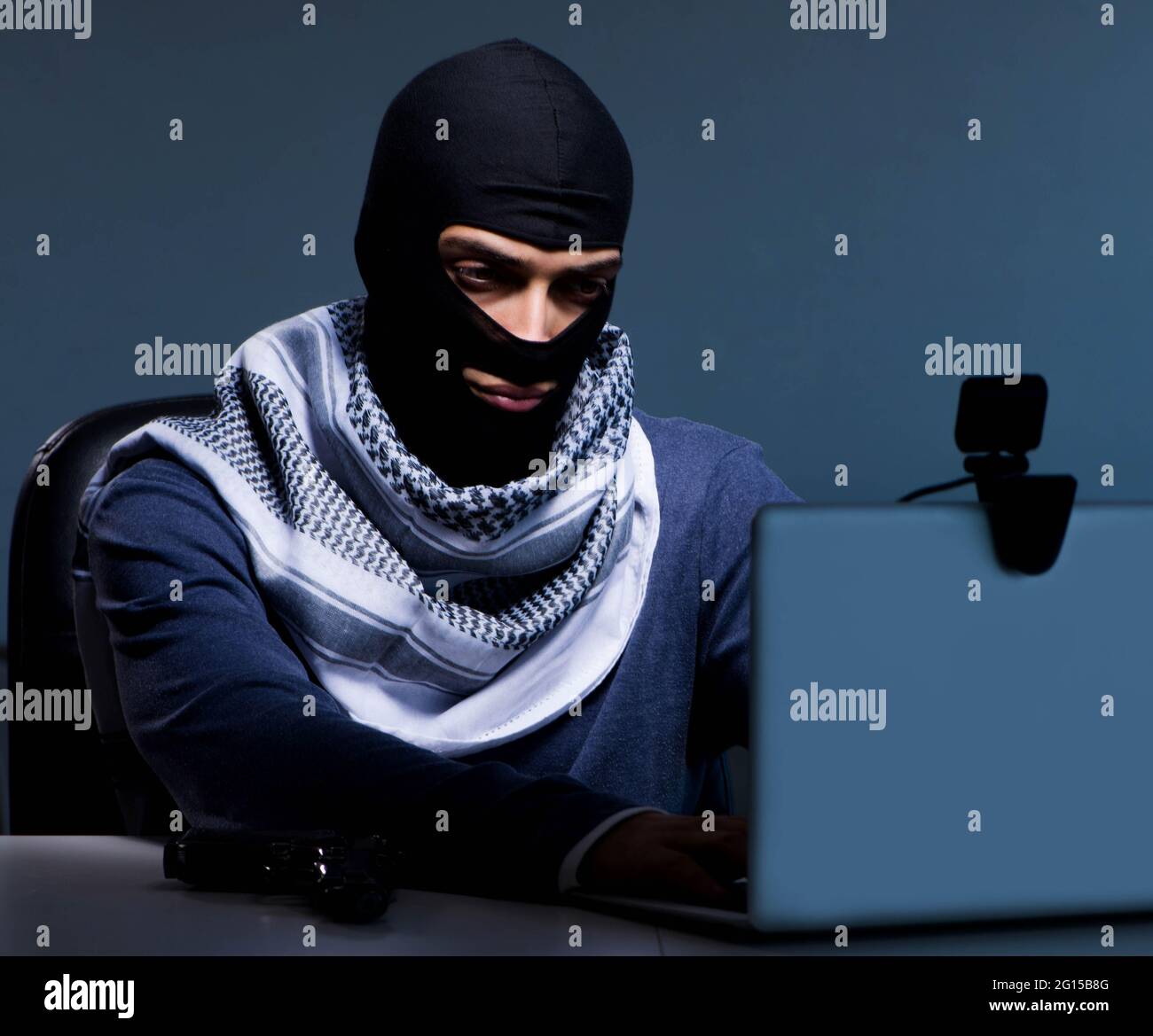 The hacker wearing balaclava mask hacking computer Stock Photo - Alamy