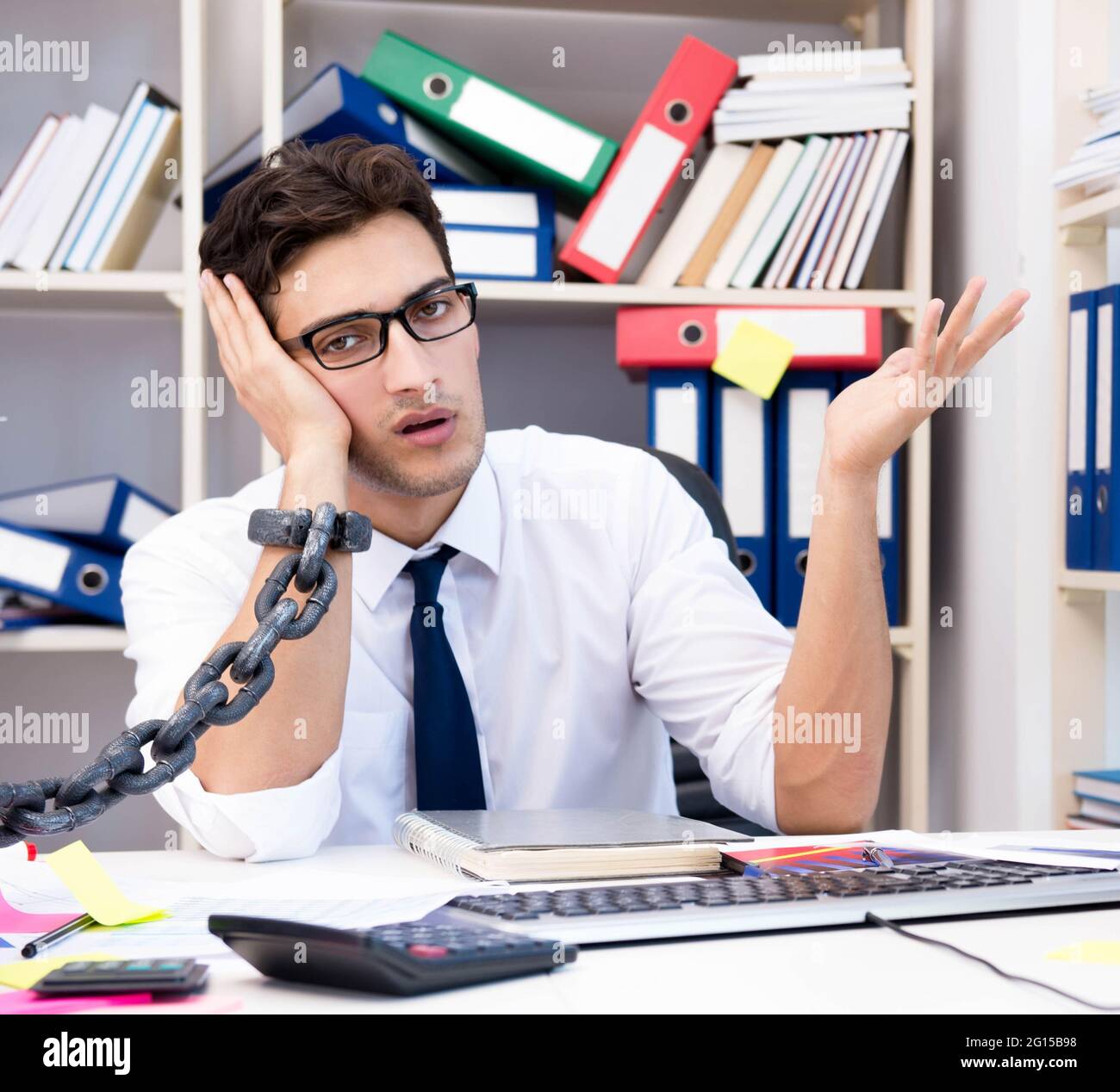 The employee attached and chained to his desk with chain Stock Photo ...