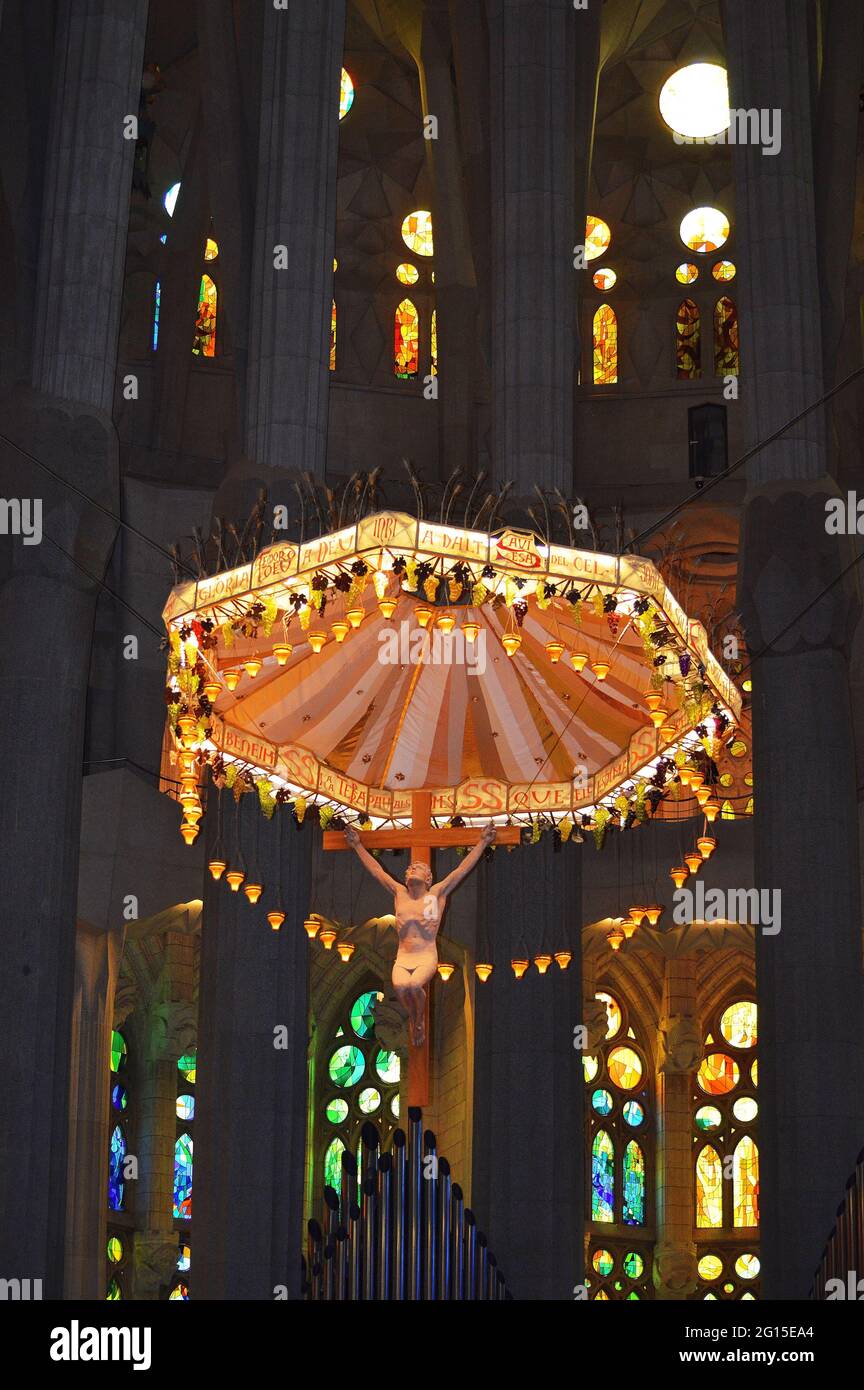 Sculpture of the crucifix amid colorful lights inside La Sagrada ...