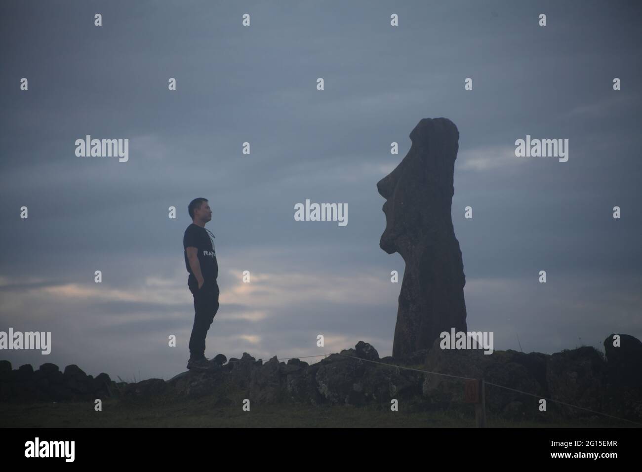 A man with Moai Statue, Easter Island, Chile Stock Photo - Alamy