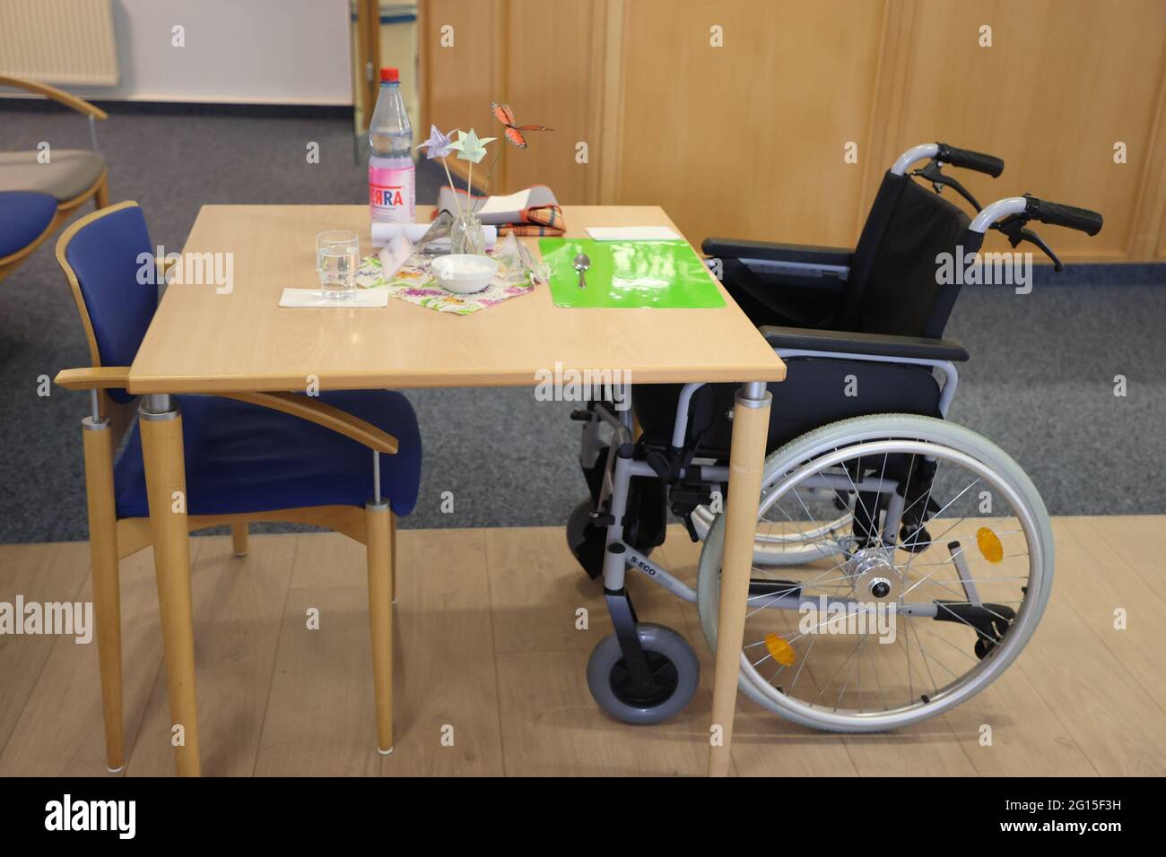 Jena, Germany. 04th June, 2021. A wheelchair stands at a dining table ...