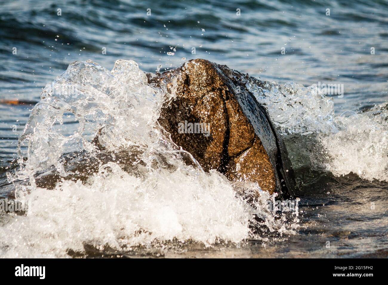 Water splashing a rock Stock Photo - Alamy