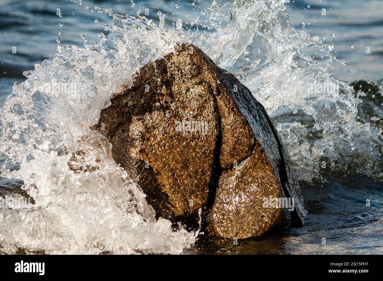 Water splashing a rock Stock Photo - Alamy
