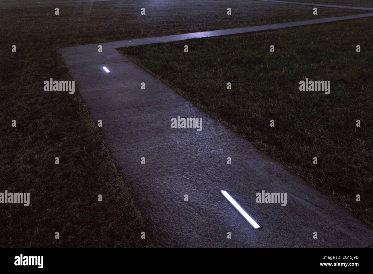 Zigzagging illuminated path, pavement, grass Stock Photo - Alamy