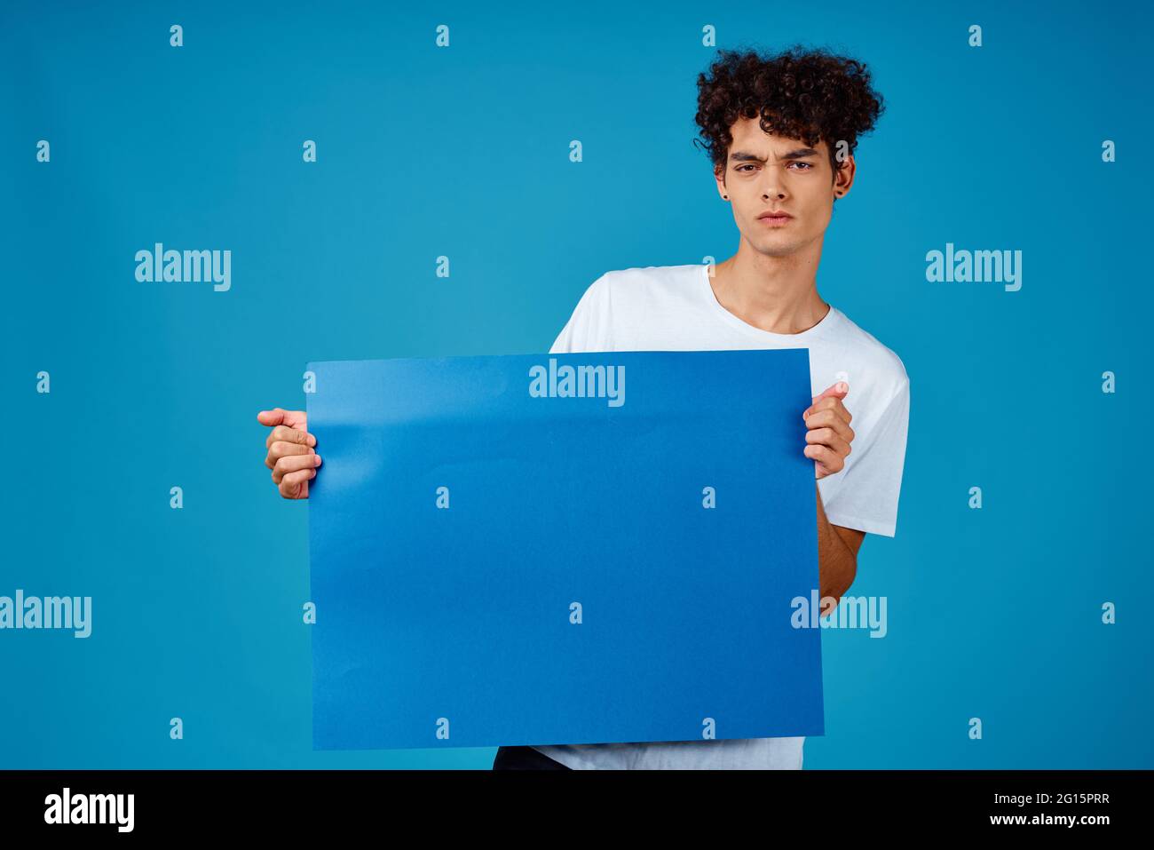 guy in white t-shirt blue poster advertising banner Stock Photo - Alamy