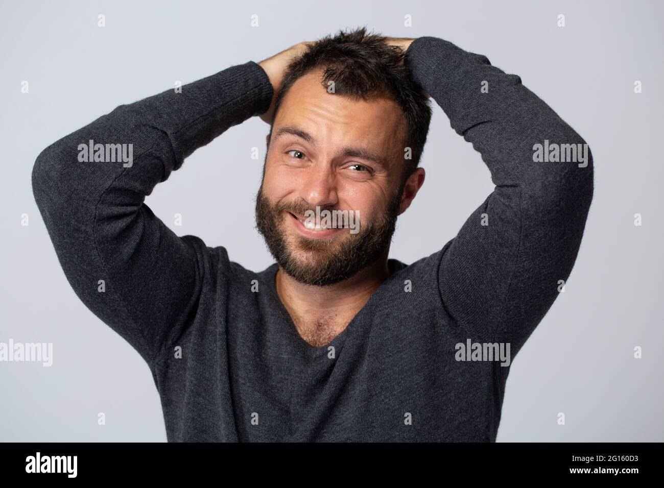 Mature contented man with beard smiling on white background with gray ...