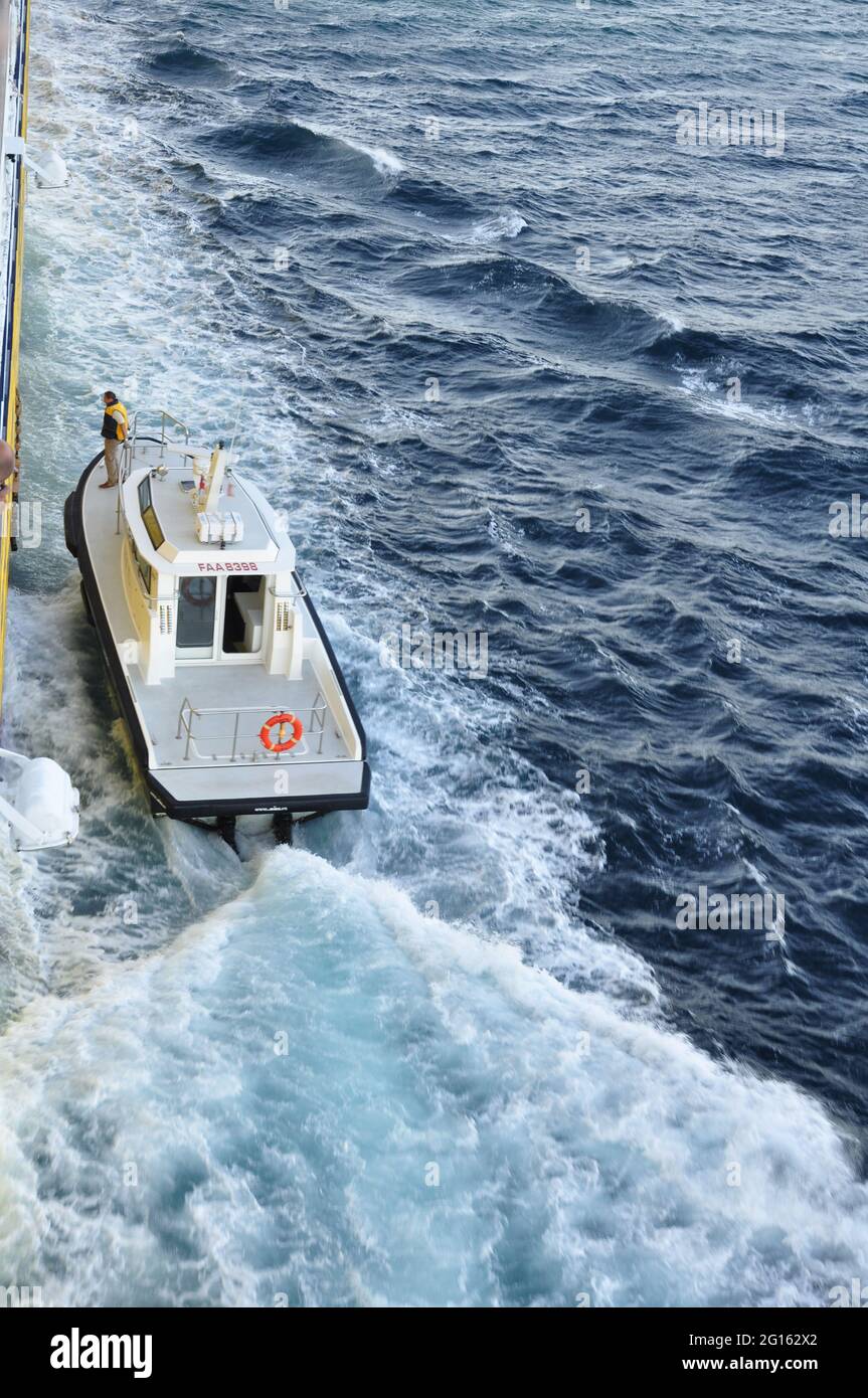 Boarding the pilot on the Mega Express ferry from the pilot's boat ...