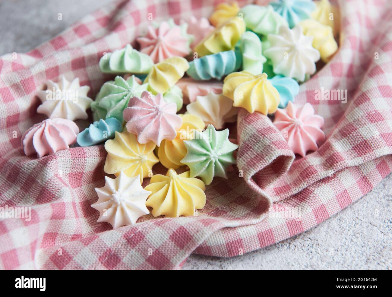Close-up delicious meringue cookies pastel colors. French pastries ...