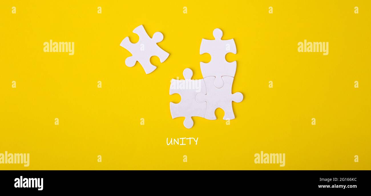Four puzzle pieces connected to each other with the word unity. Unity ...