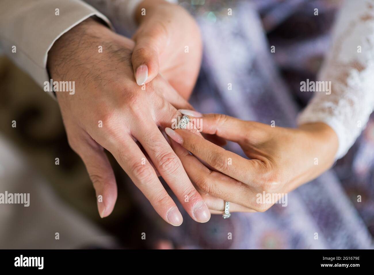 wear a ring, wedding ring, love couple Stock Photo - Alamy