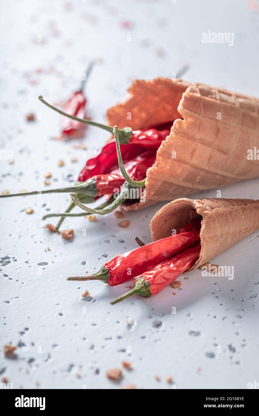 Chilli peppers on ice cream cone as strange combination of flavors. New ...