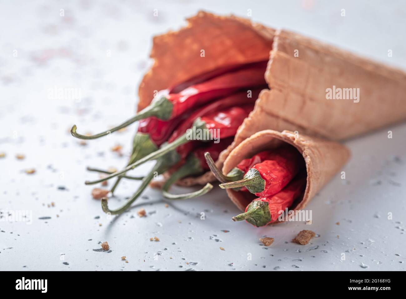 Chilli peppers in ice cream cone. Spicy ice cream. Strange ice cream ...
