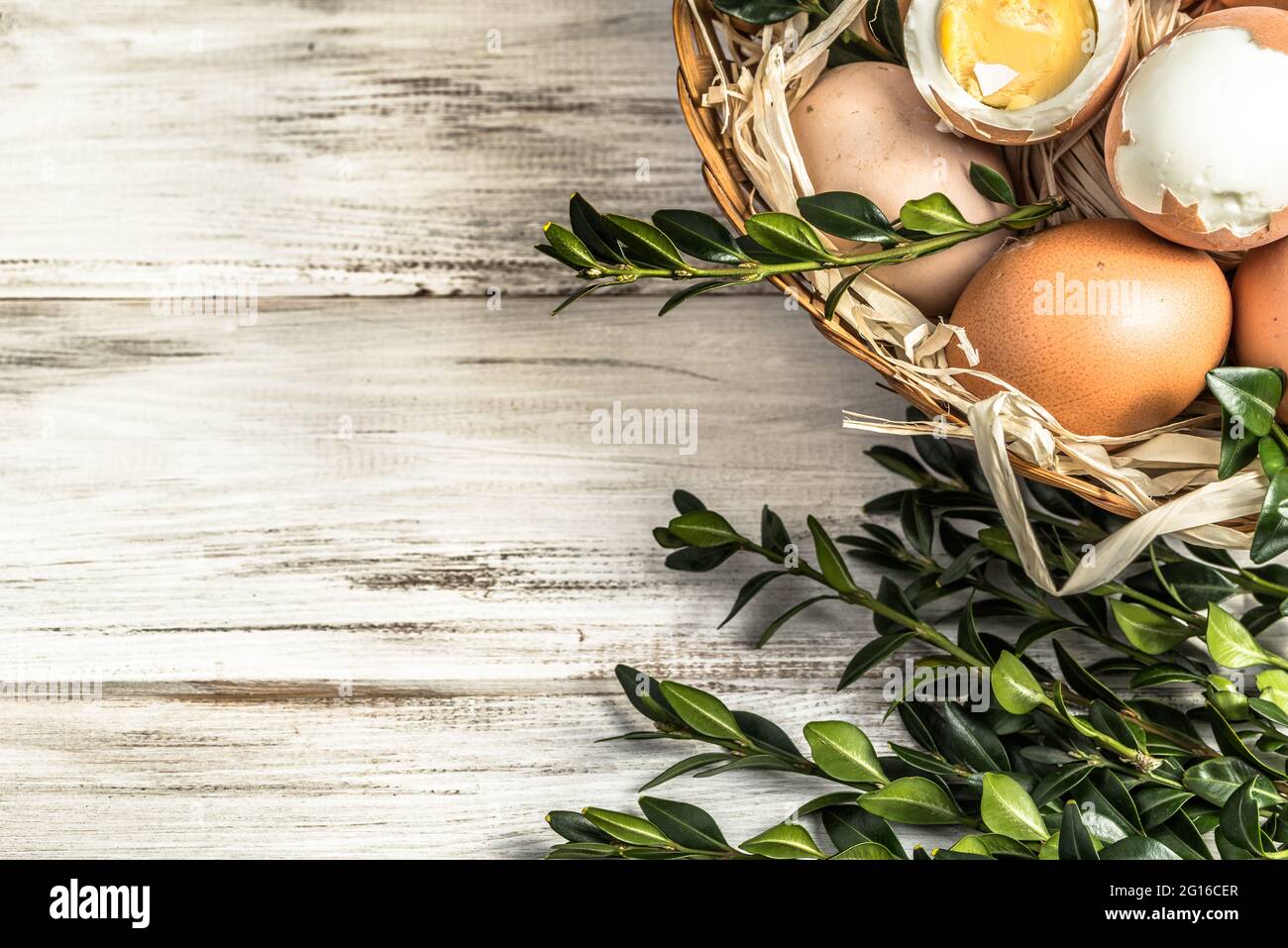 Fresh farm eggs in the basket and hard boiled egg isolated on white ...