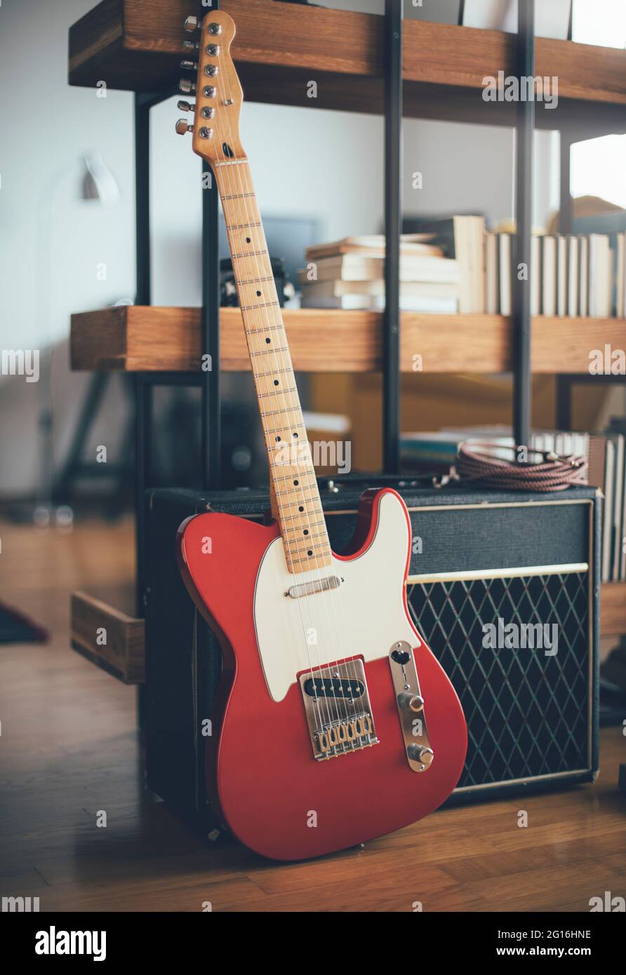 Red electric guitar and classic amplifier Stock Photo - Alamy