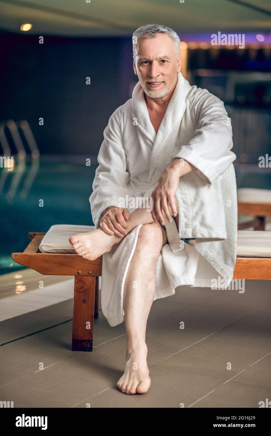 A Gray Haired Bearded Man In A White Bath Robe In Spa Center Stock