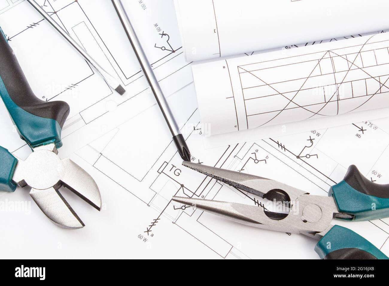 Metal pliers, screwdriver and diagrams of plan with electrical ...
