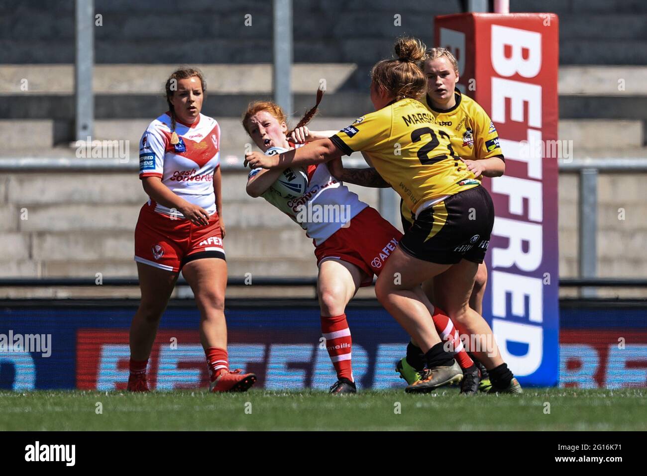 Rebecca Rotherham (2) of St Helens is tackled by Rhiannon Marshall of ...