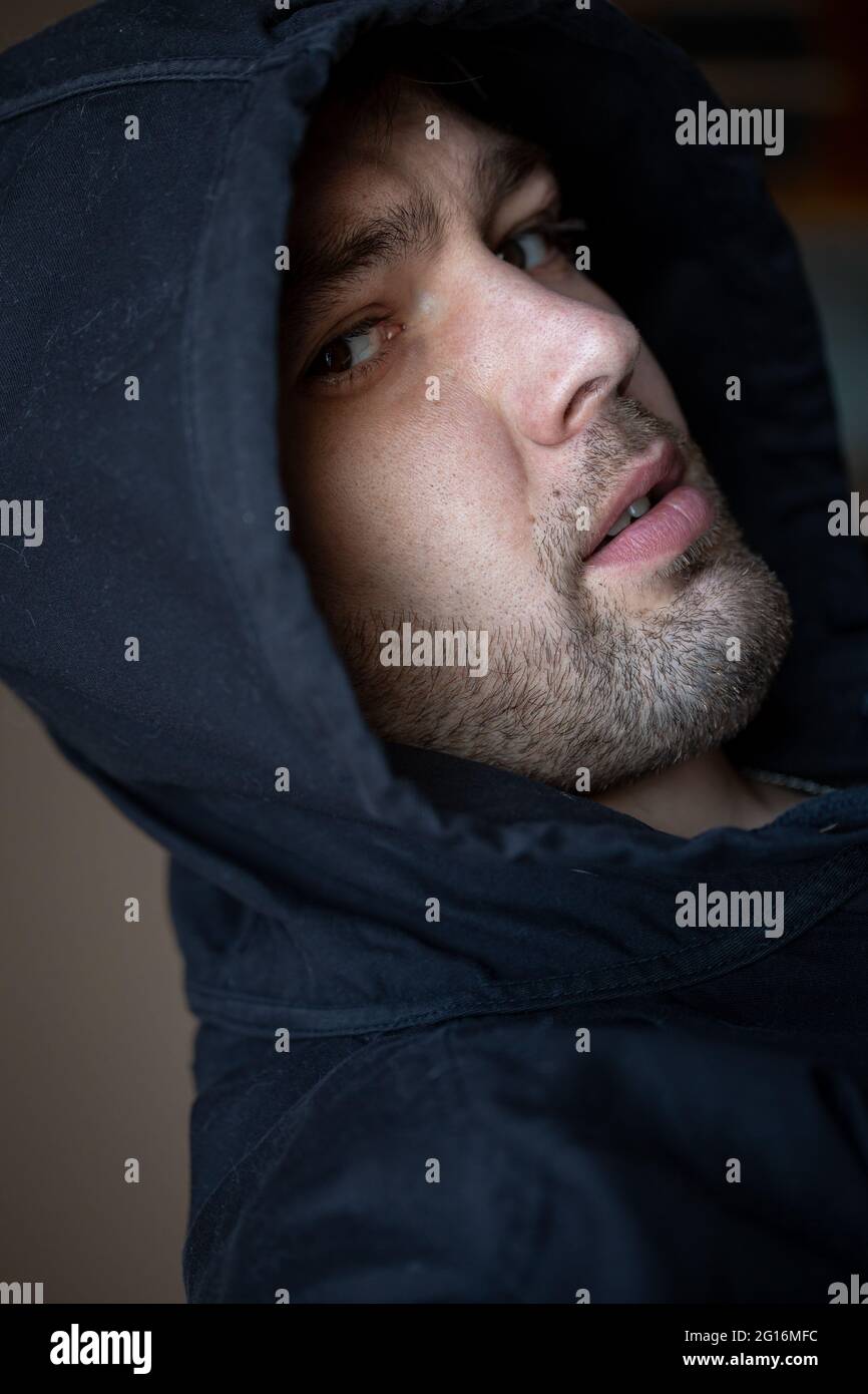 guy in a black hooded large portrait Stock Photo - Alamy