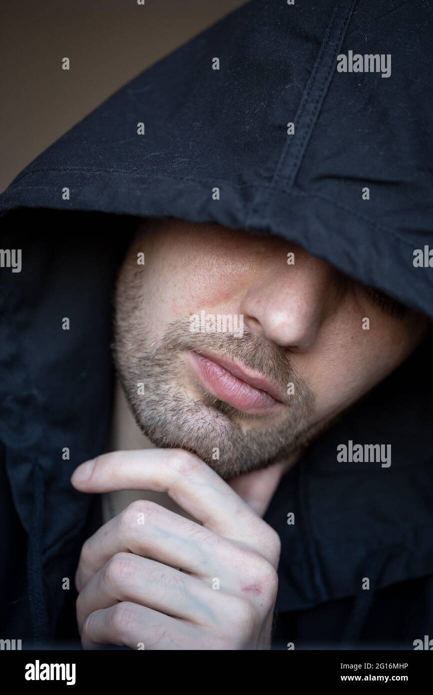 a guy in a black hood with a close-up portrait Stock Photo - Alamy