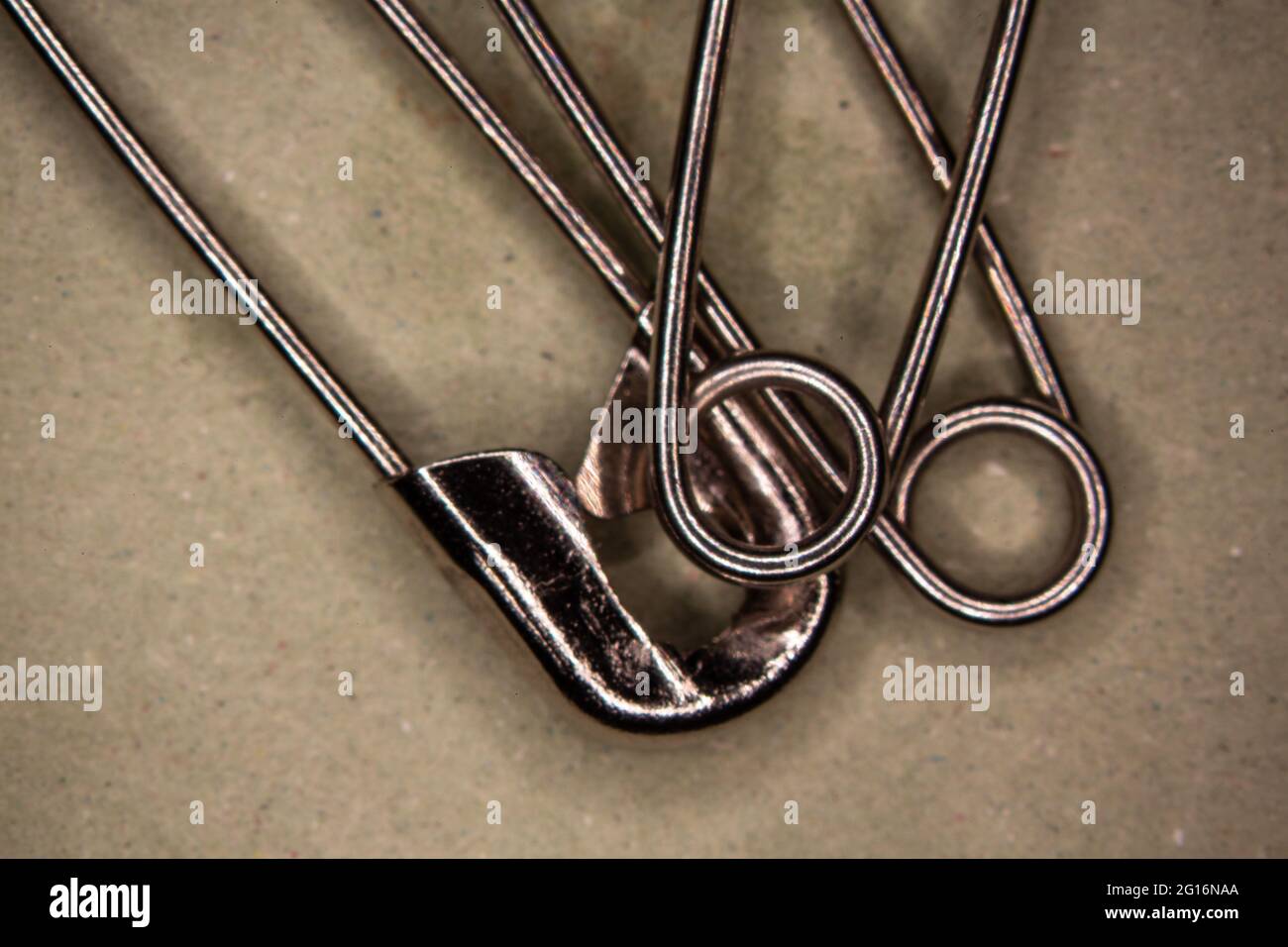 metallic safety pins in close-up Stock Photo - Alamy