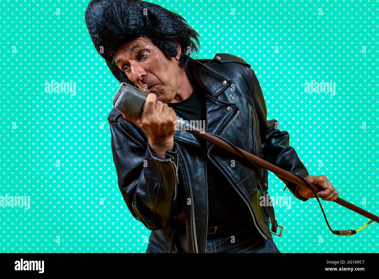 Funny portrait of mature rocker. An old singer dressed in rockabilly ...